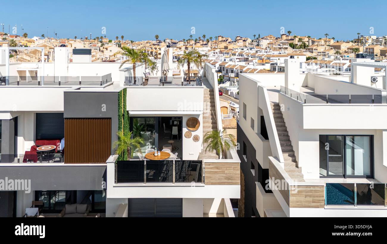 Stylish apartment complex with rooftop terrace and balconies ...