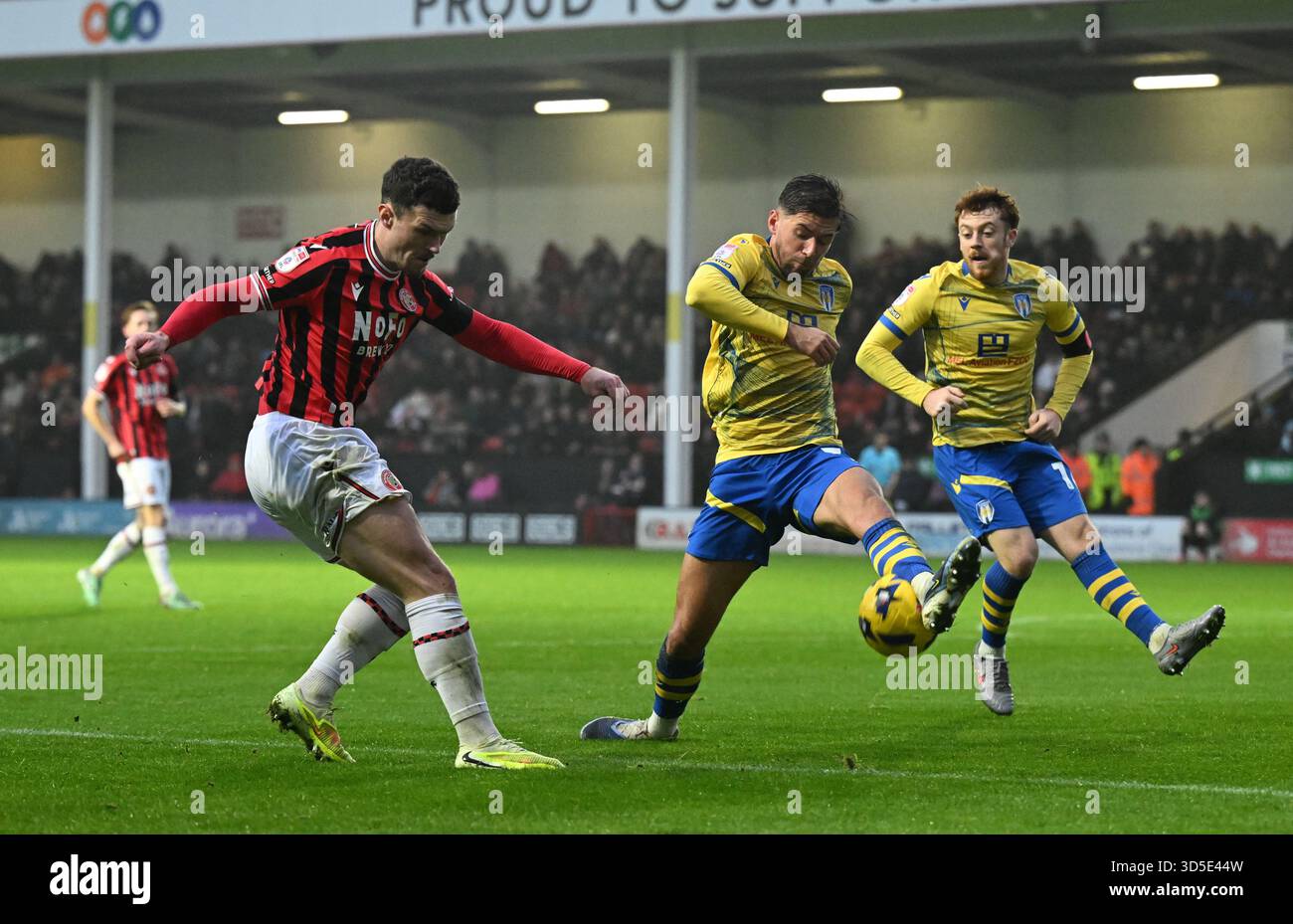 Walsall's Connor Barrett's (left) cross is blocked by Colchester United ...
