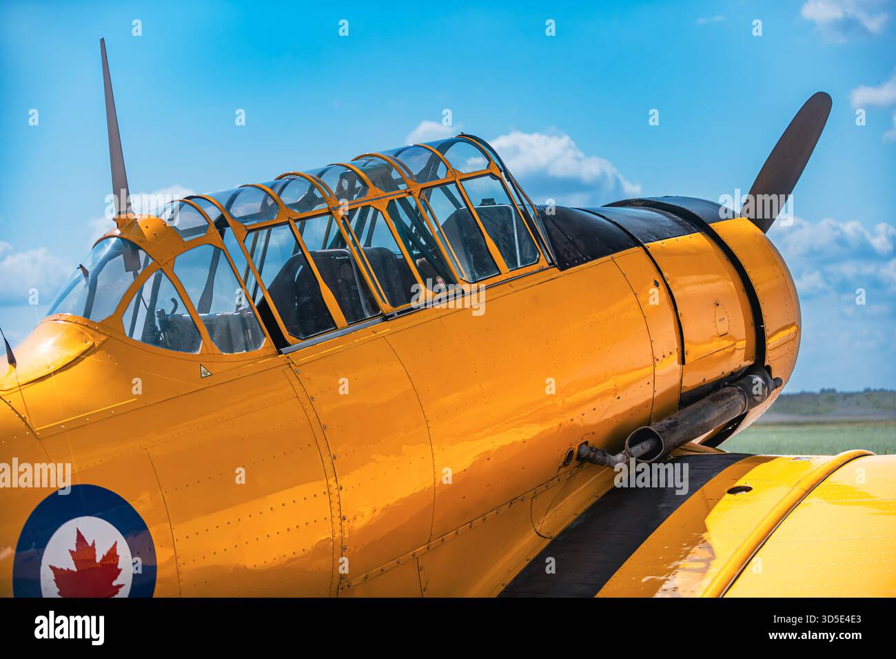 Side view close-up of vintage yellow military training aircraft cockpit ...