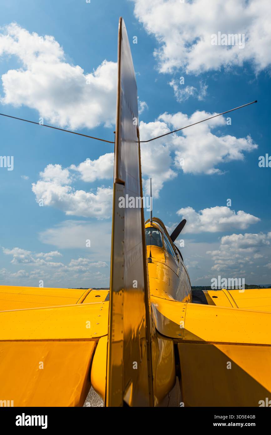 Low angle rear view of vintage yellow military training aircraft on ...