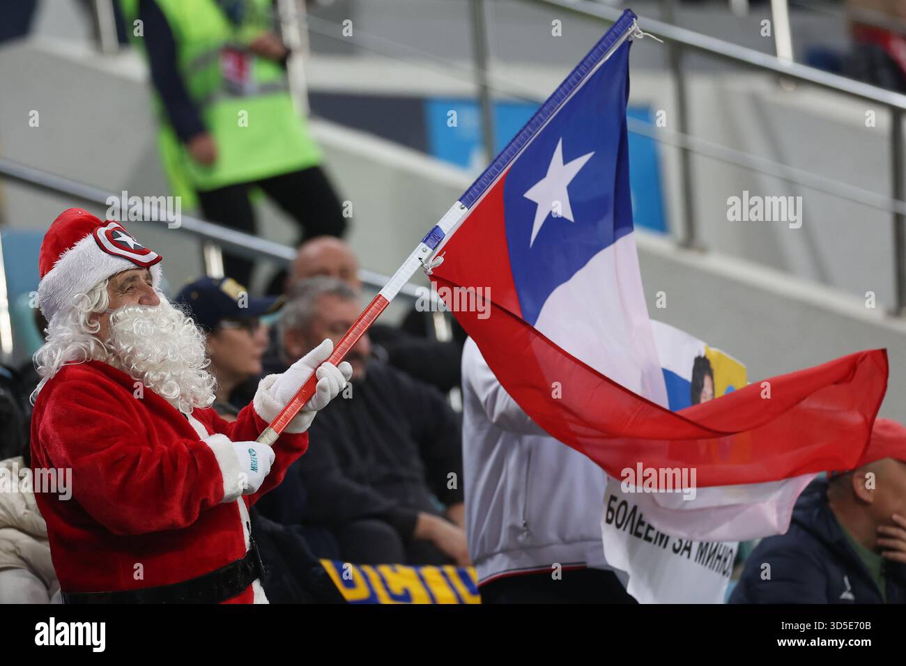 A fan waves Chilean flag during an international friendly soccer match ...