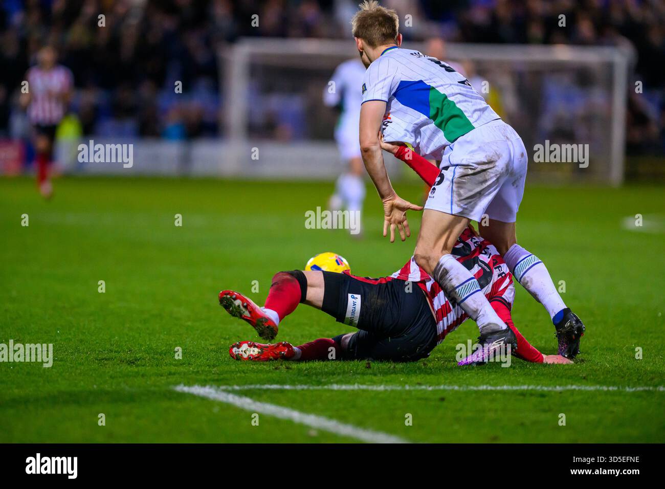 Nathan Smith of Tranmere Rovers FC falls over Jake Bickerstaff of ...