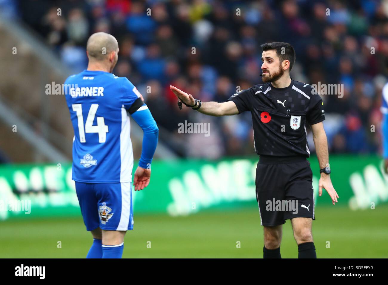 Joe Garner of Oldham Athletic is cautioned BY REFEREE Aaron Farmer ...