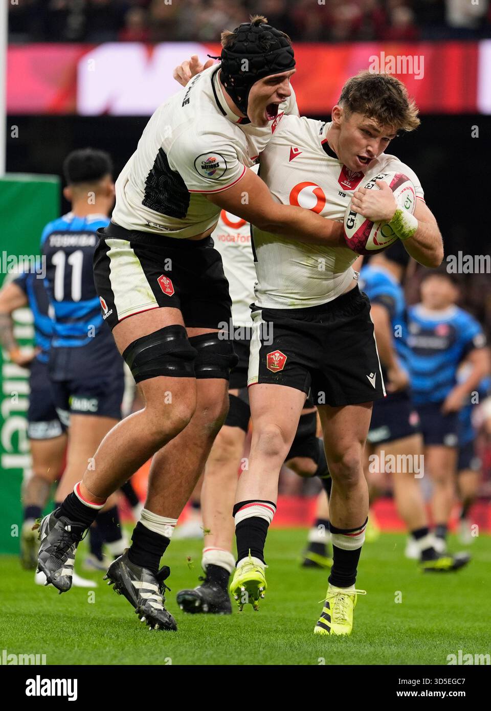 Wales' Dan Edwards (right) celebrates with a teammate after scoring ...