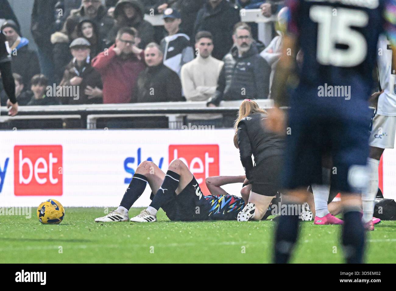 Lewis Shipley (3 Barrow) lays on pitch receiving medical treatment ...