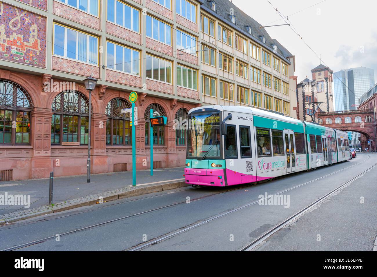 Frankfurt, Germany - October 21, 2025: Modern pink and teal tram moves ...