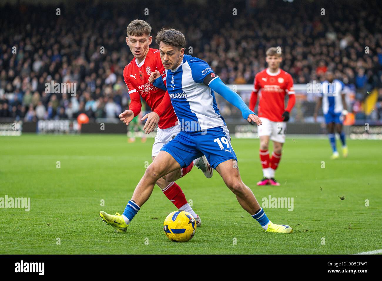 Luke Hannant of Oldham Athletic battles for possession during the ...
