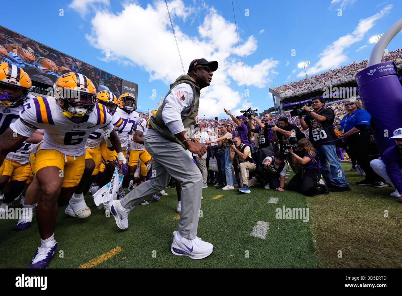 LSU interim head coach Frank Wilson III leads the team onto the field ...