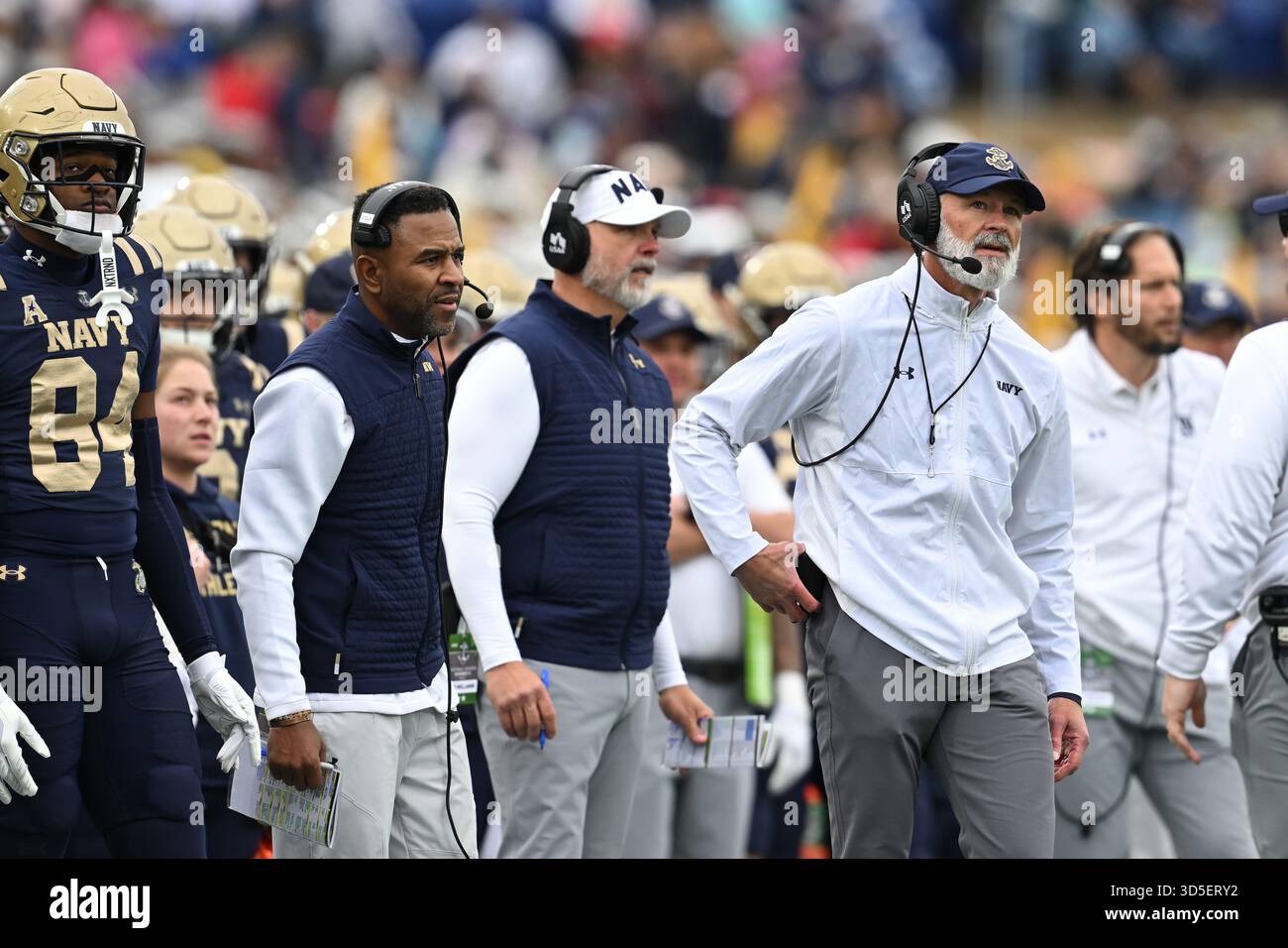 Navy head coach Brian Newberry, right, looks on during the first half ...