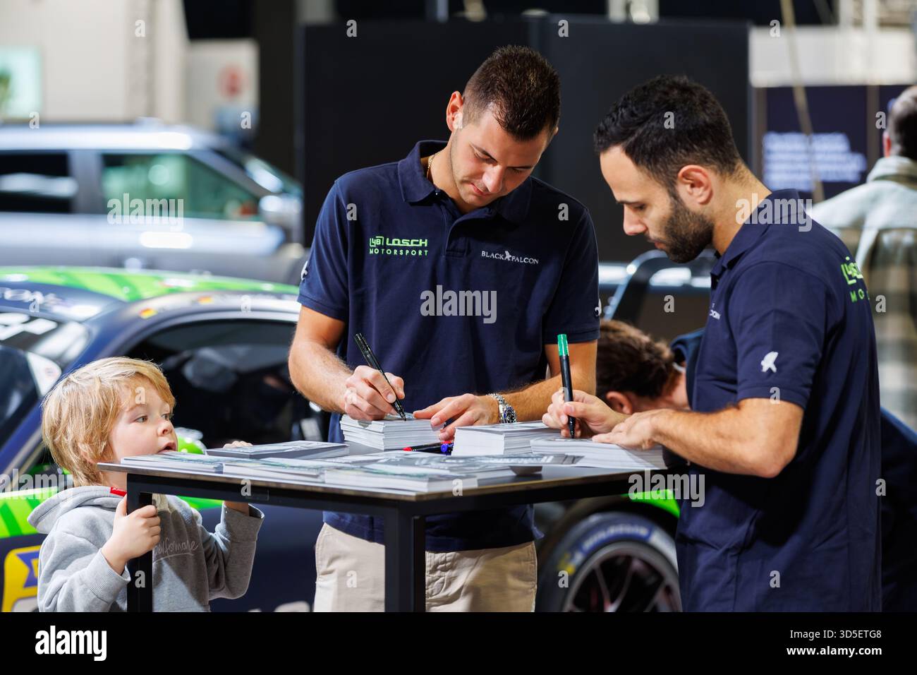 Racing drivers sign autograph cards featuring Carlos Rivas, Dylan ...
