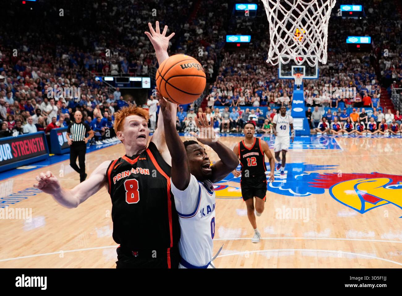 Kansas guard Nginyu Ngala (0) shoots under pressure from Princeton ...