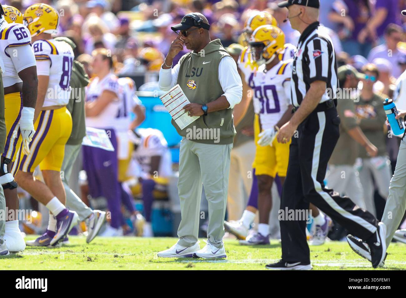 LSU Tigers head coach Frank Wilson III looks at his call sheet during a ...
