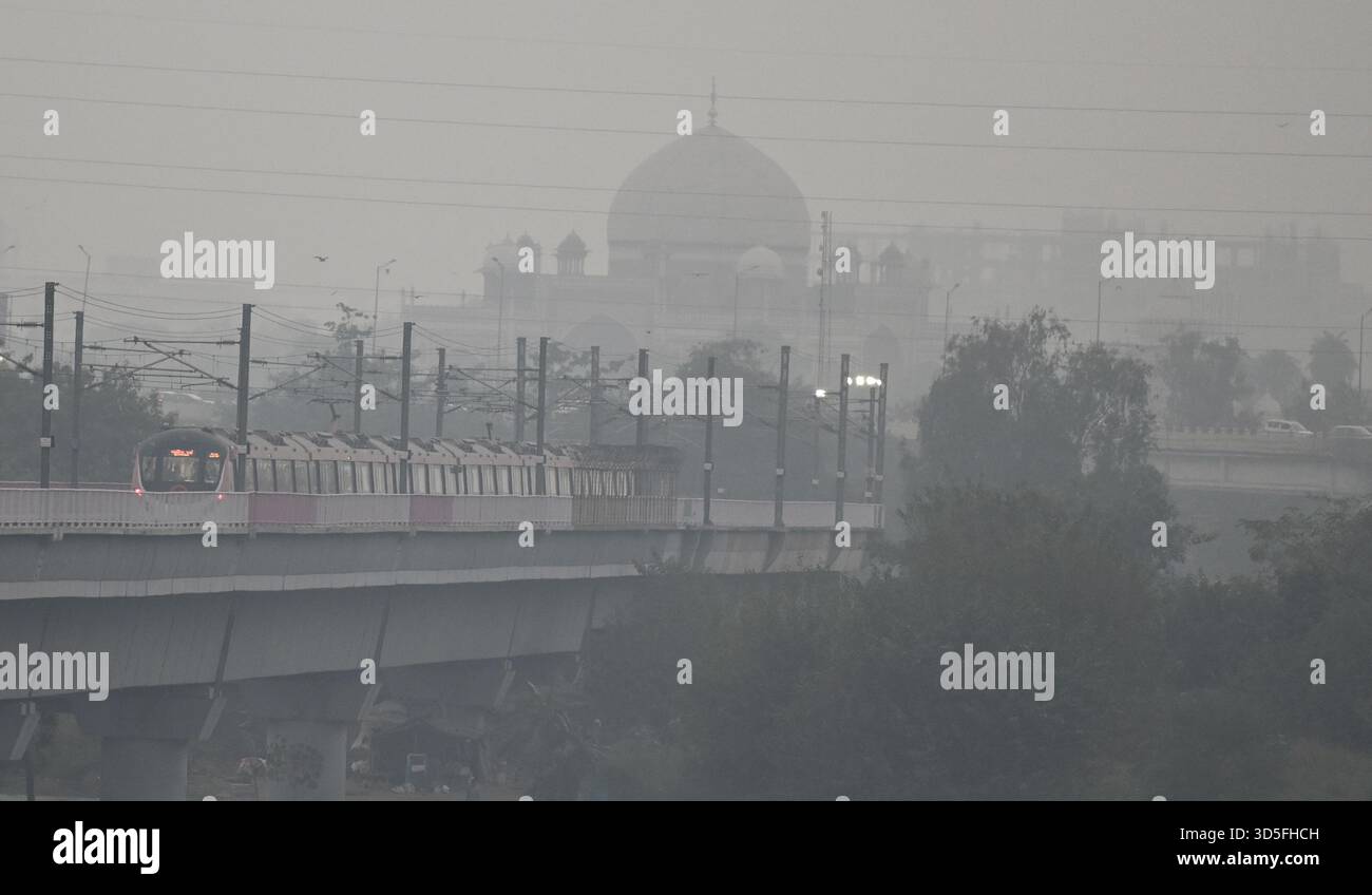 NEW DELHI, INDIA - NOVEMBER 15: A metro train moves along the tracks ...
