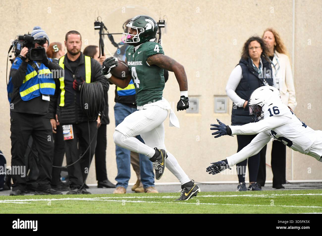 Michigan State running back Elijah Tau-Tolliver, left, runs for a ...
