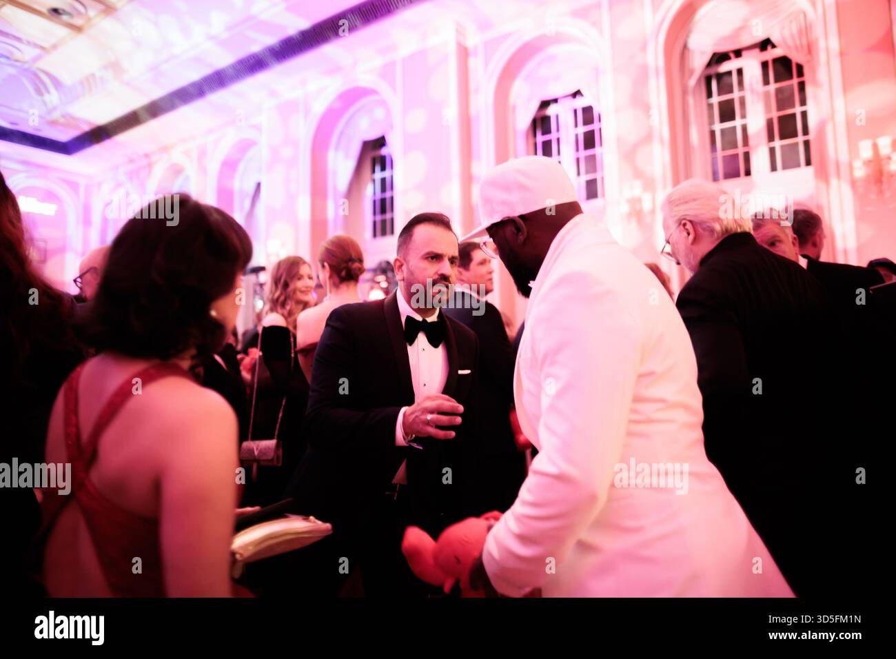 15 November 2025, Berlin: Guests stand at the Hip-Hop Ball in the Rotes ...