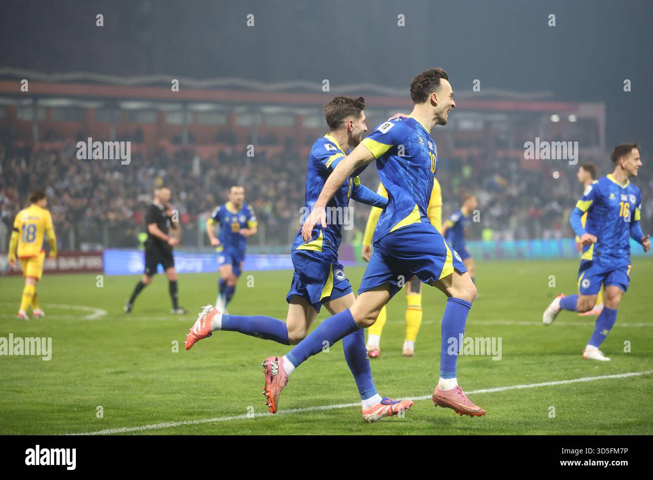 Bosnia's Haris Tabakovic, centre right, celebrates with Armin Gigovic ...