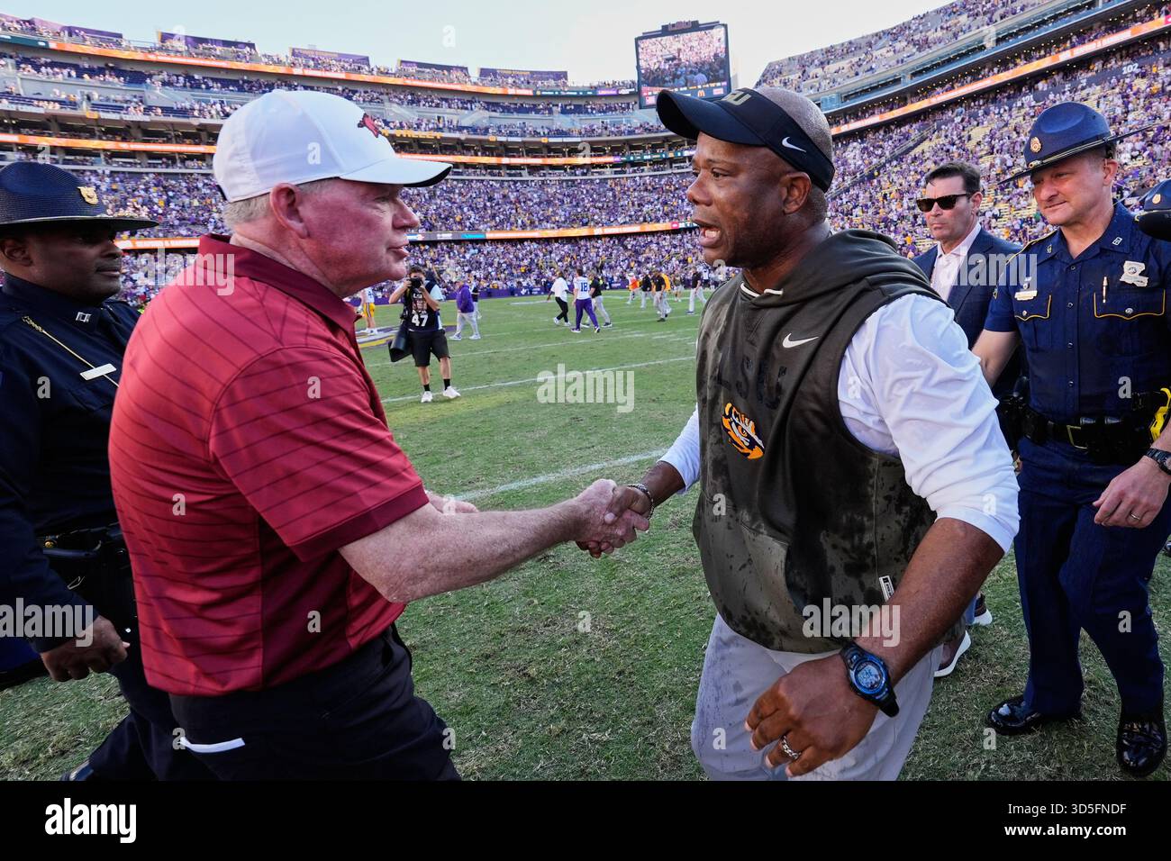 LSU interim head coach Frank Wilson III, right, greets Arkansas interim ...