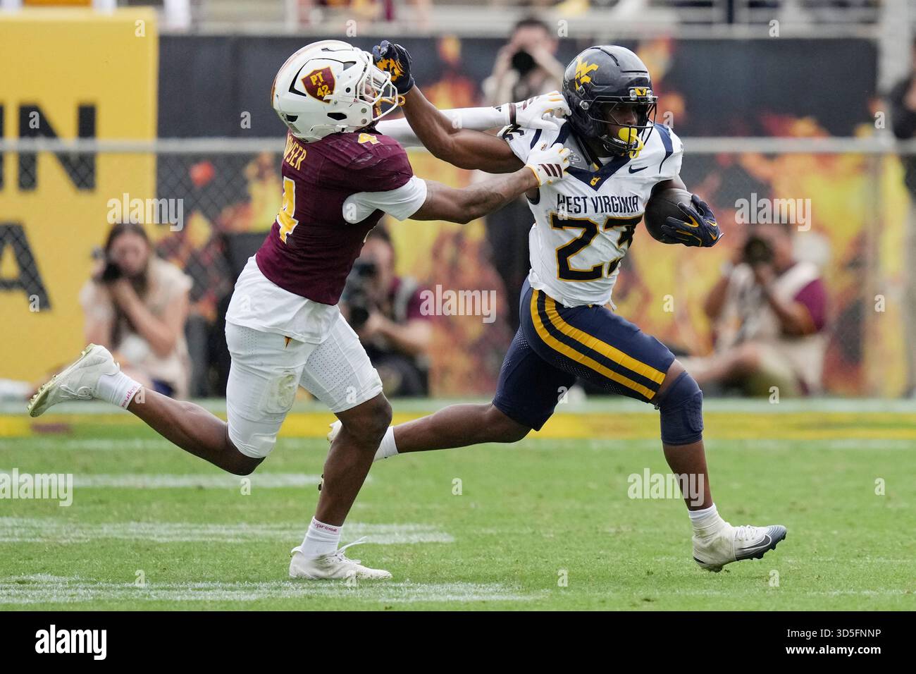 Arizona State running back Demarius Robinson (23) tries to get away ...