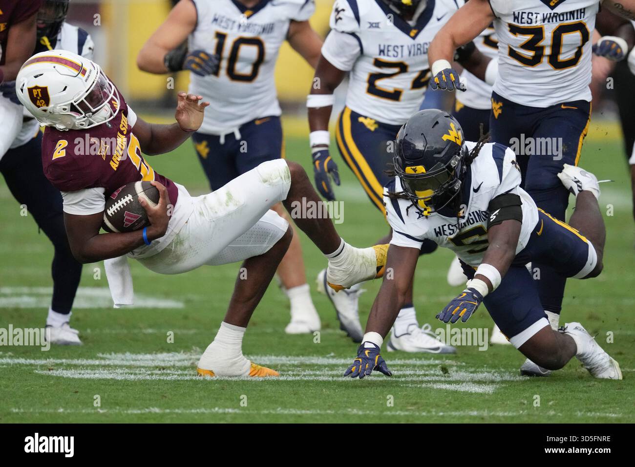 Arizona State quarterback Jeff Sims (2) gets tackled by West Virginia ...