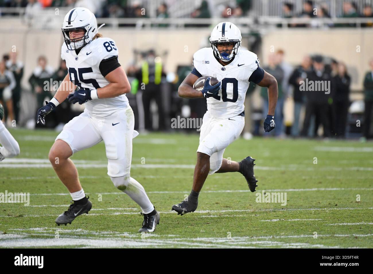 Penn State running back Nicholas Singleton, right, runs with the ball ...