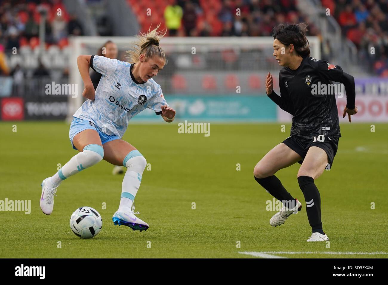 Kaylee Hunter #11 of AFC Toronto dribbles the ball against Yuka Okamoto ...