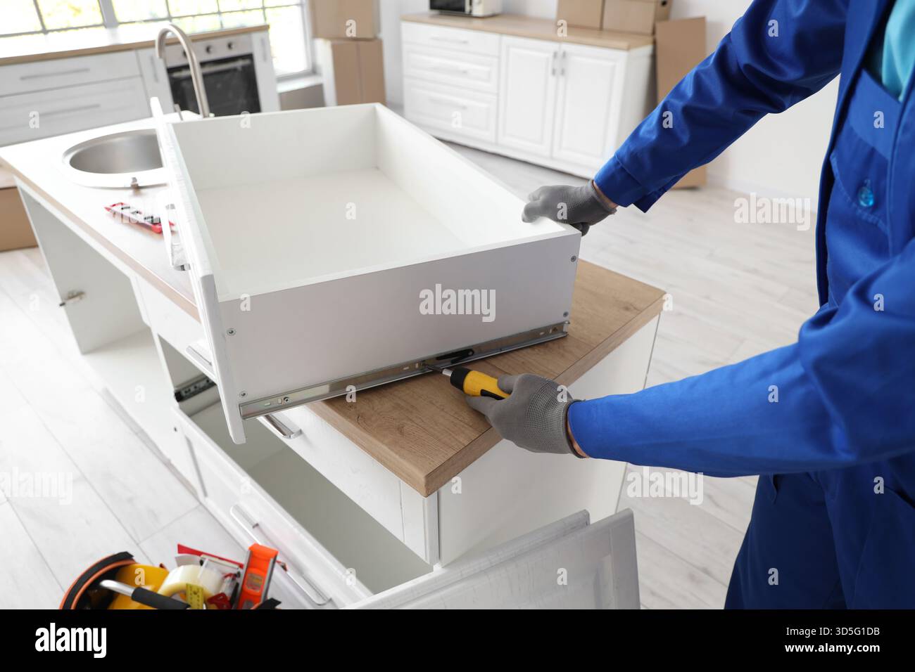 Caucasian handyman installing drawer hi-res stock photography and ...