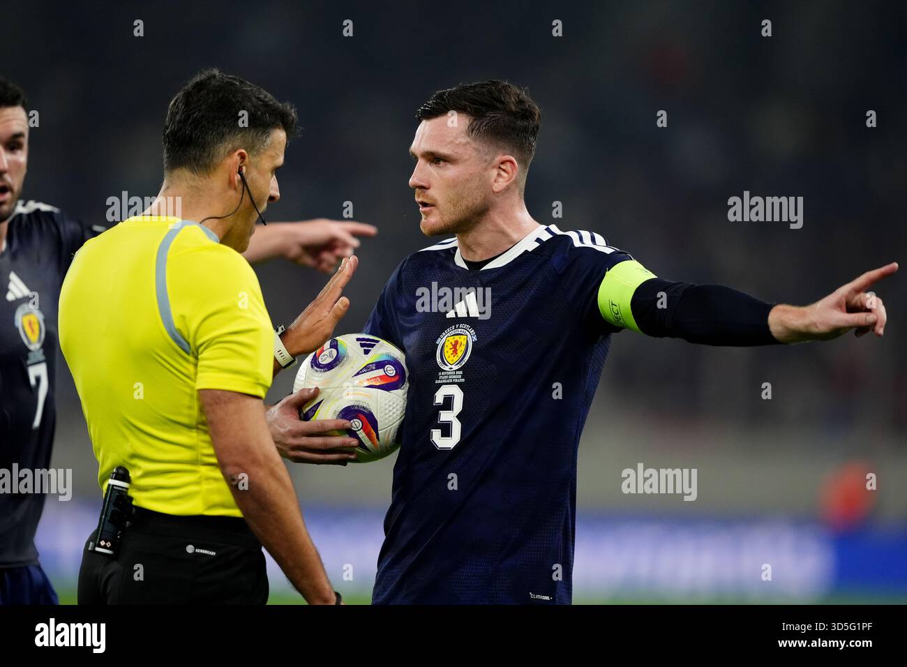 Scotland's Andrew Robertson (right) speaks with referee Jesus Gil ...