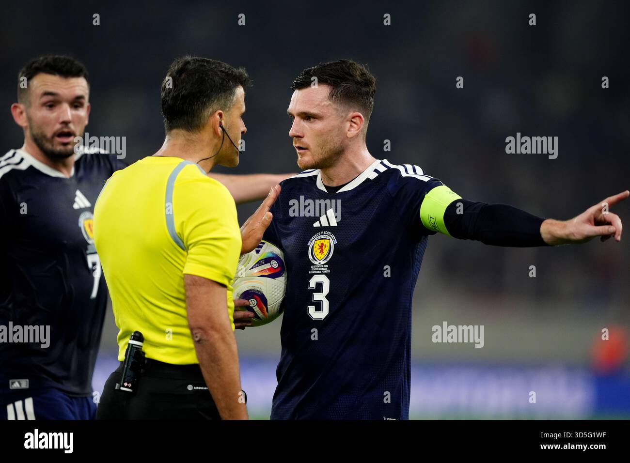 Scotland's Andrew Robertson (right) speaks with referee Jesus Gil ...