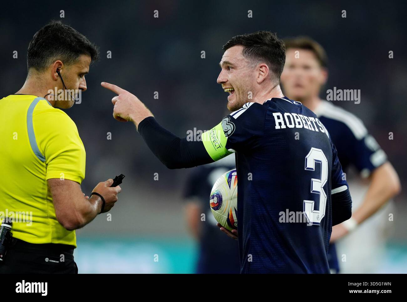Scotland's Andrew Robertson (right) speaks with referee Jesus Gil ...