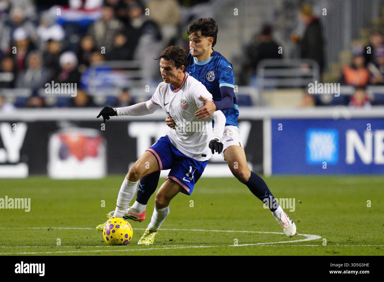 United States' Brenden Aaronson, front, controls the ball past Paraguay ...