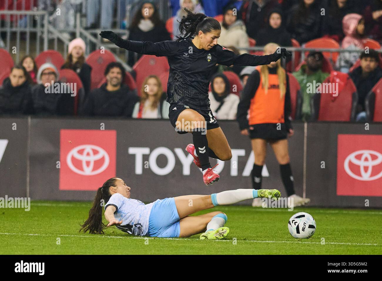 Vancouver Rise FC forward Holly Ward (19) jumps over a slide tackle by ...