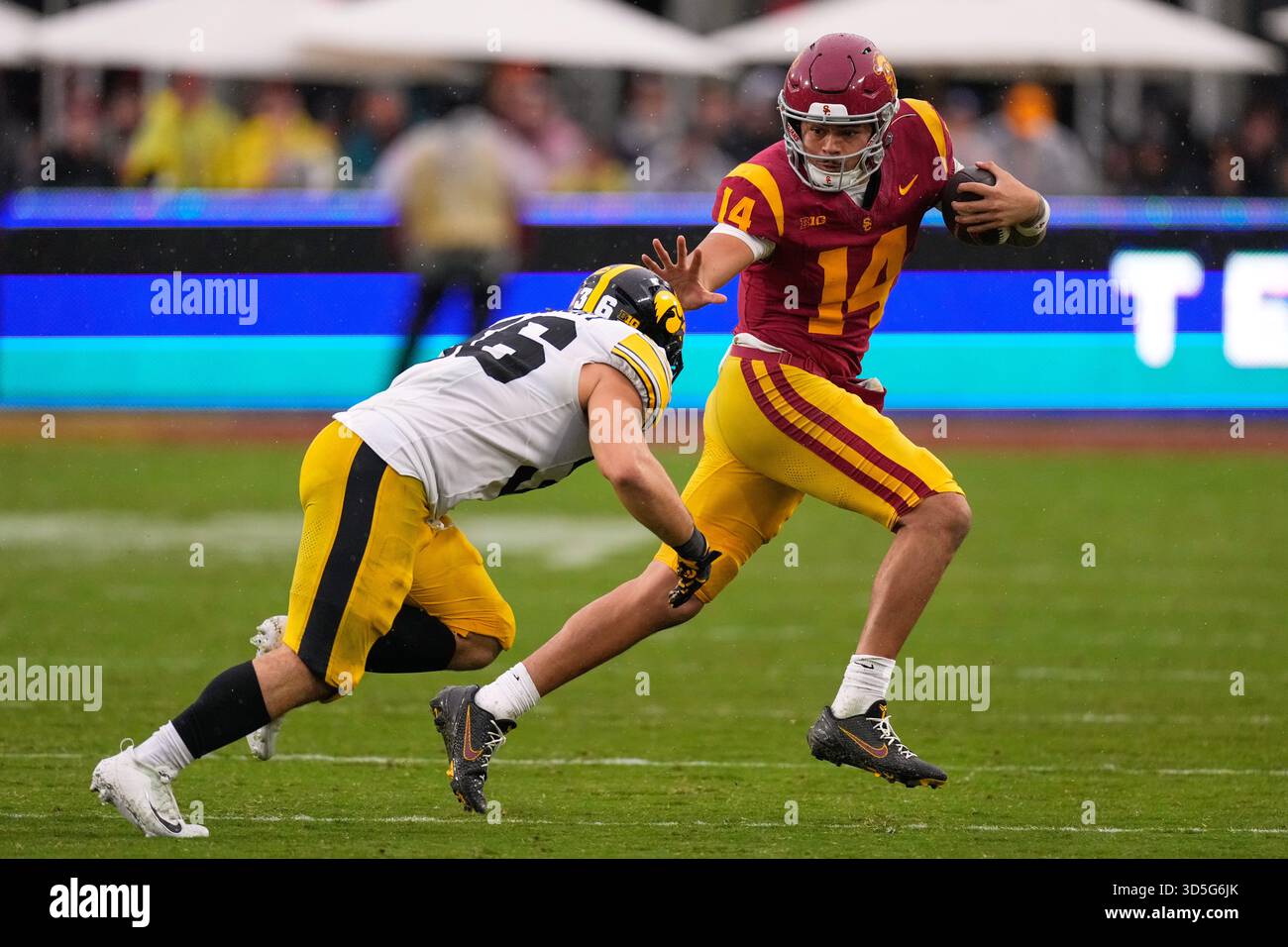 Southern California quarterback Jayden Maiava, right, fends off Iowa ...