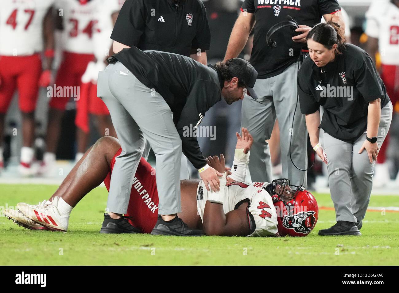 North Carolina State defensive tackle Brandon Cleveland (44) is helped ...