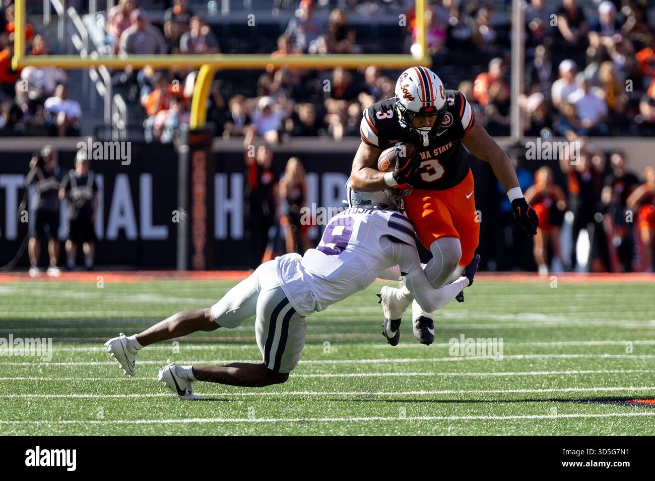 Kansas State cornerback Donovan McIntosh (9) tackles Oklahoma State ...