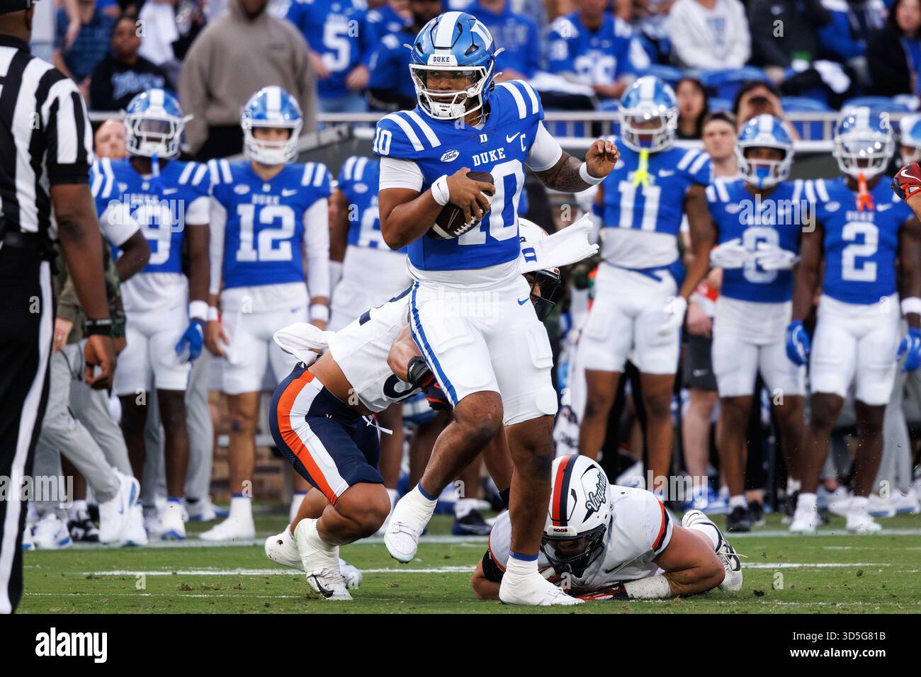 Duke quarterback Darian Mensah (10) spins away from Virginia's Landon ...