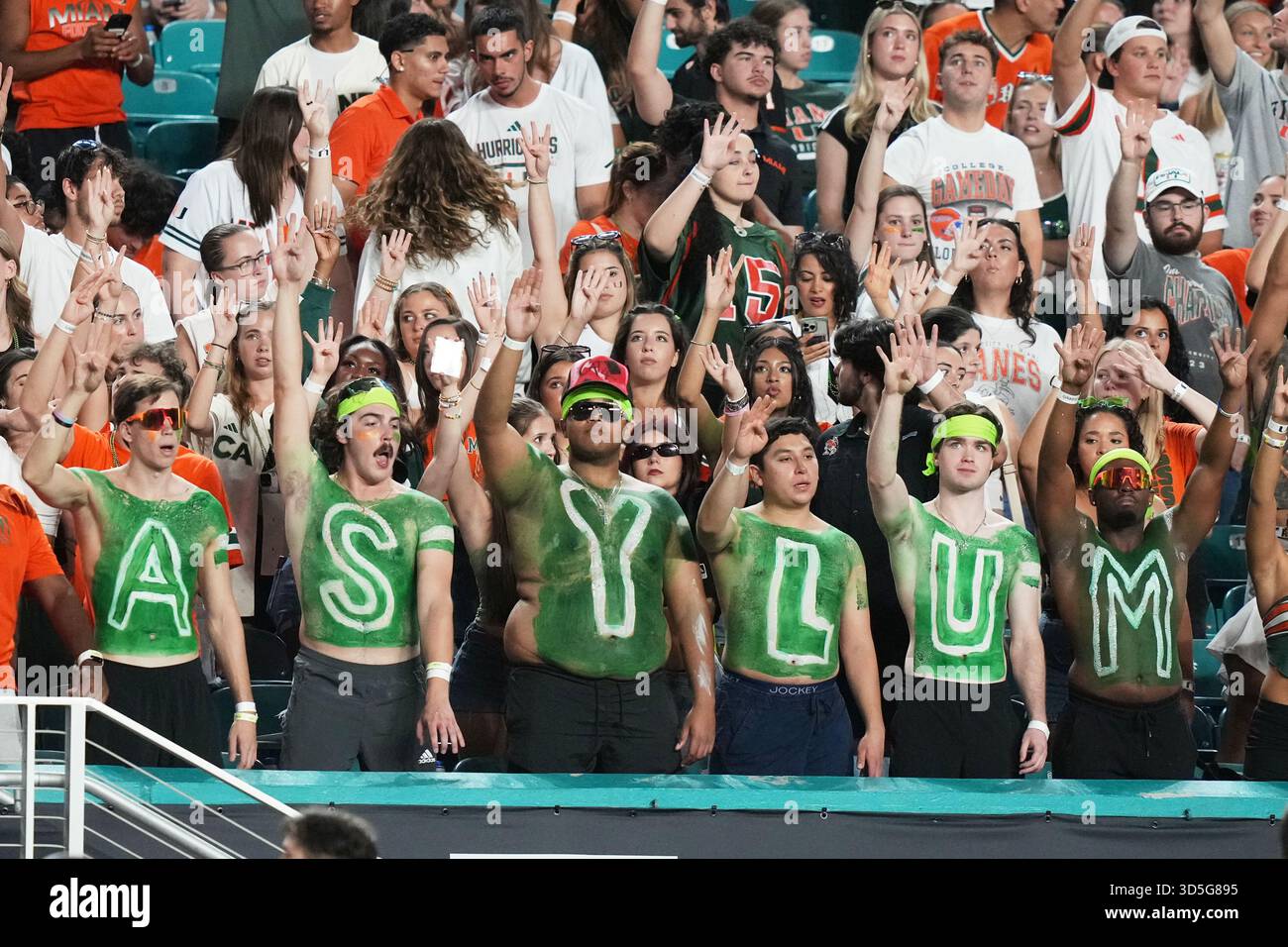 Miami fans cheer during the second half of an NCAA college football ...
