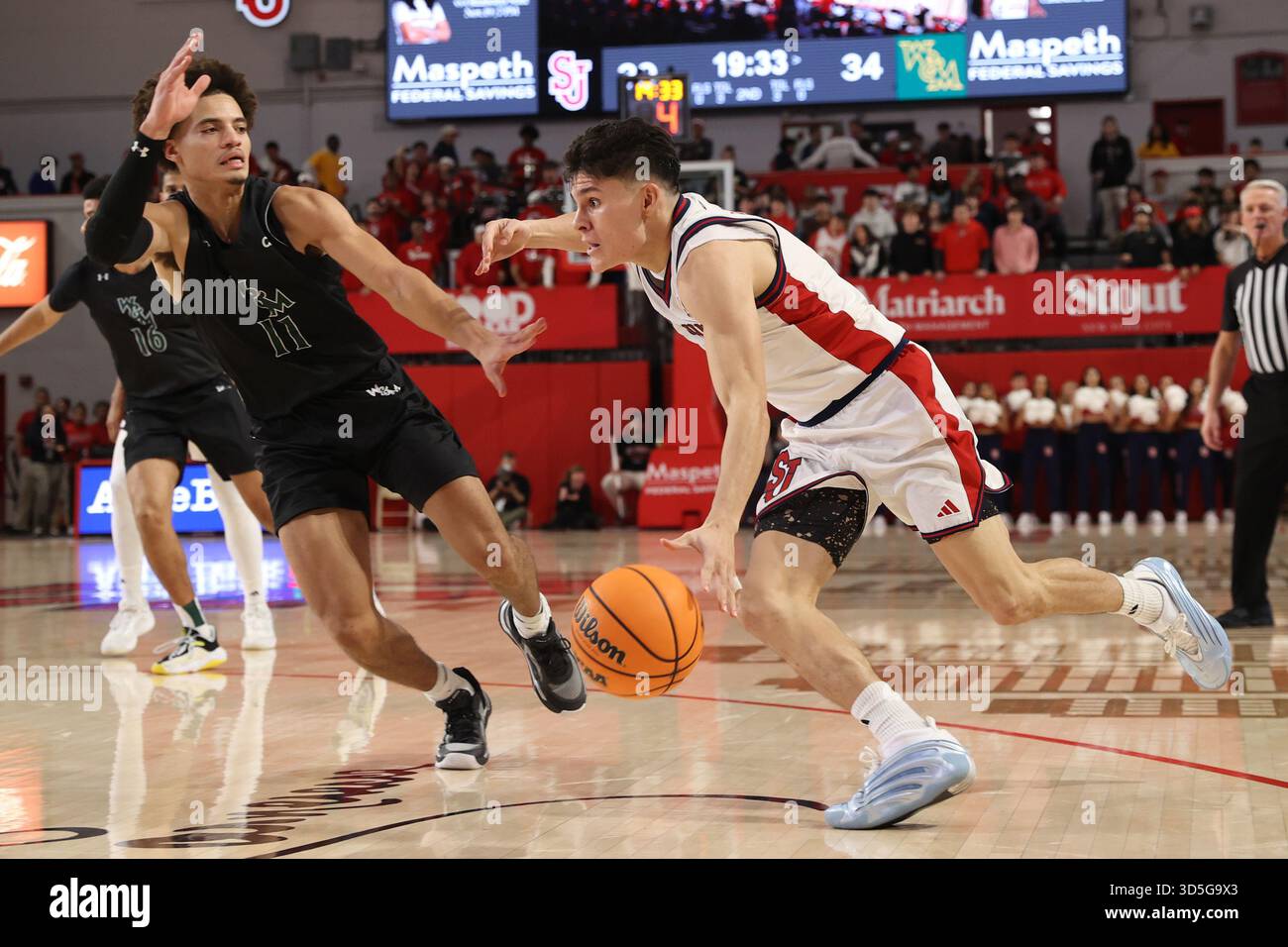 St. John's guard Dylan Darling, right, dribbles the ball against ...