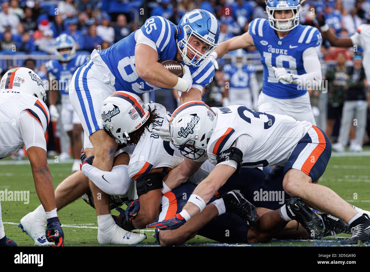 Duke's Jeremiah Hasley (85) is hit by Virginia's Landon Danley, middle ...