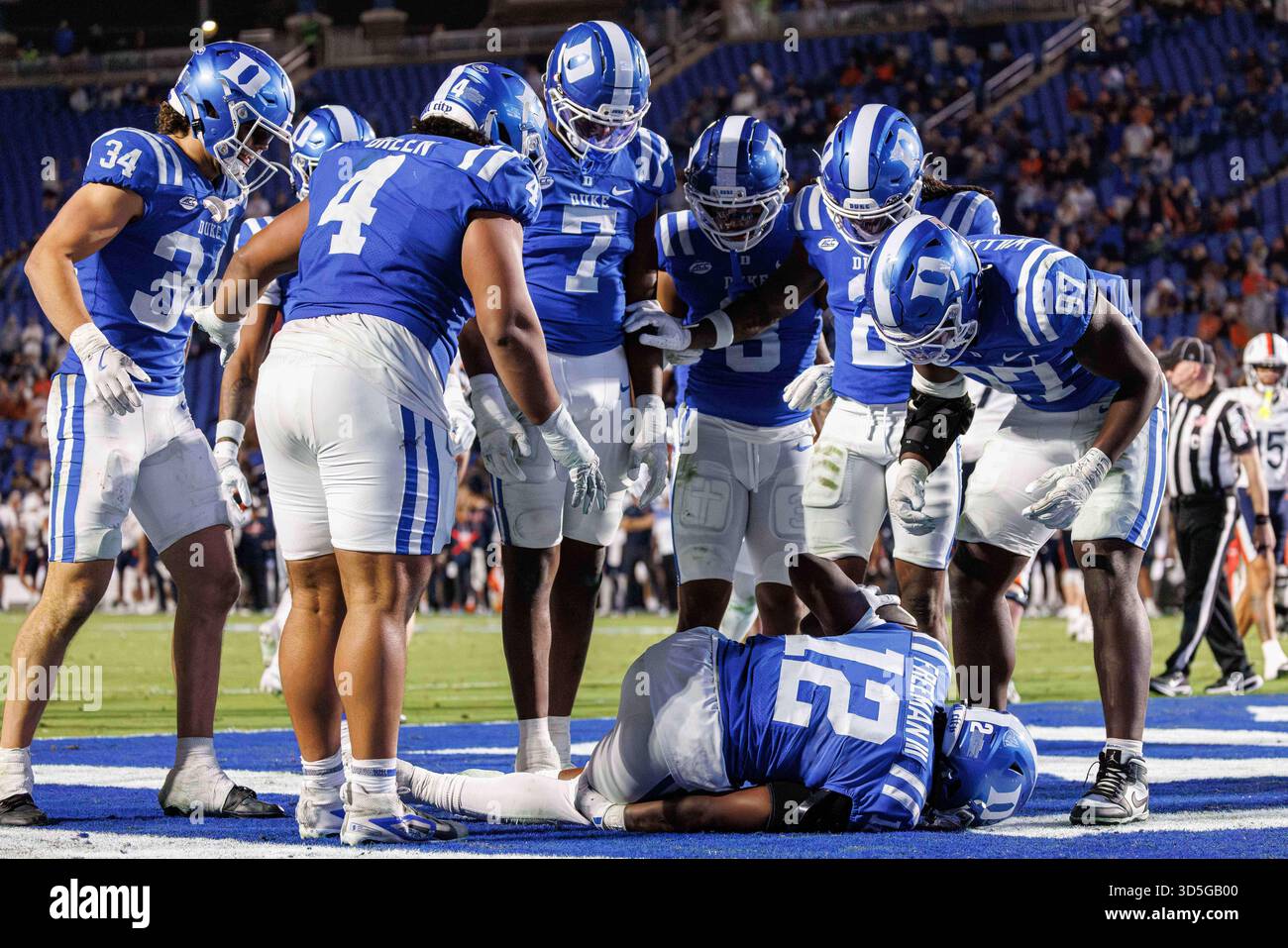 Teammates stand over Duke's Tre Freeman (12) after he was injured while ...