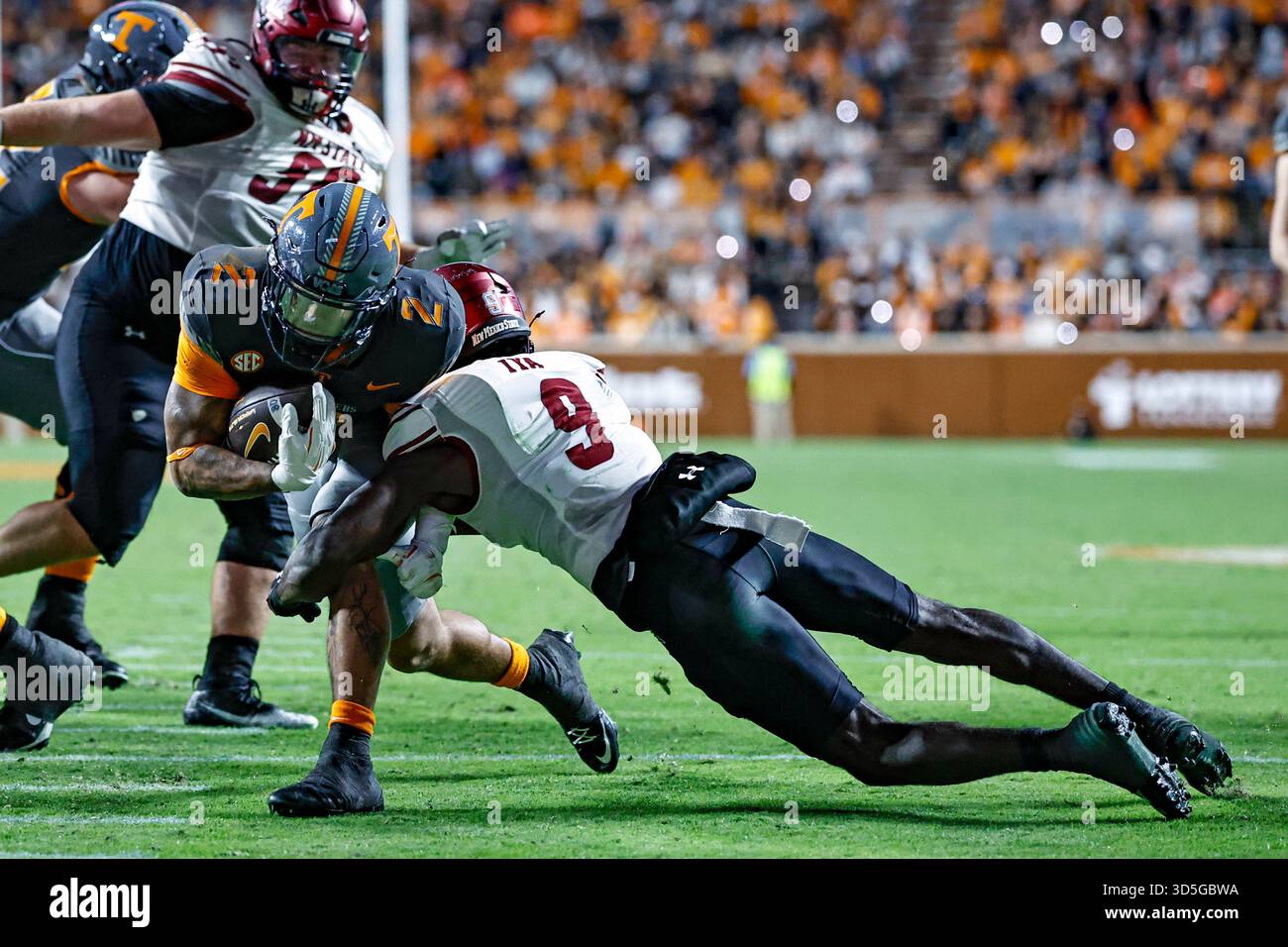 Tennessee running back Peyton Lewis (2) makes it out of a tackle ...