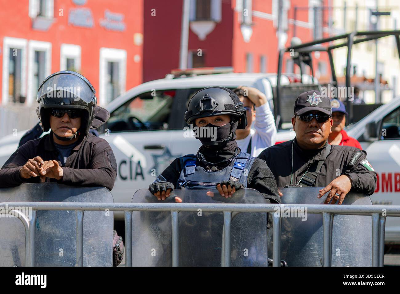 Close-up of three riot police officers, wearing tactical gear, helmets ...