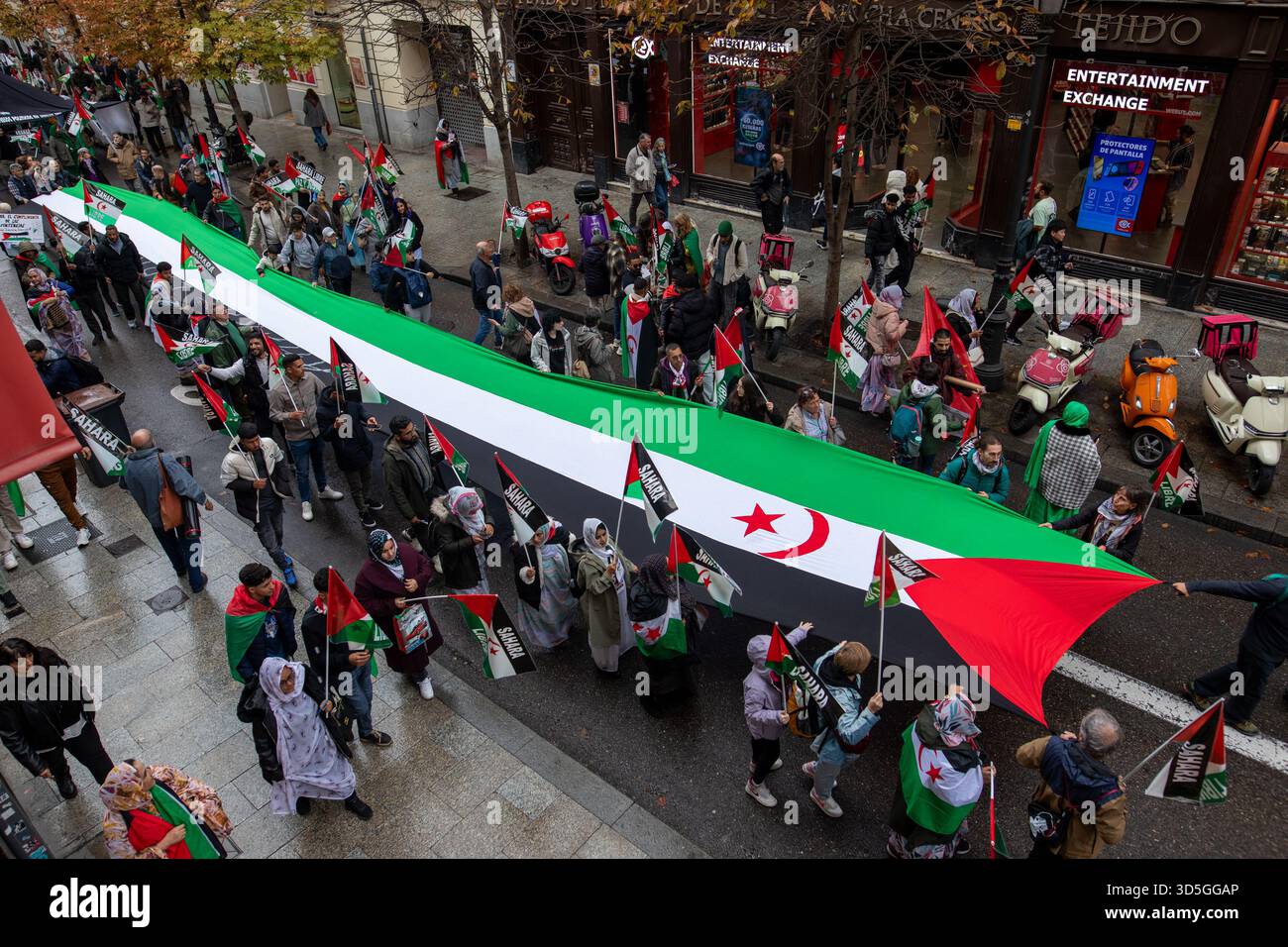 Protesters march with a giant Sahrawi flag during the demonstration. A ...
