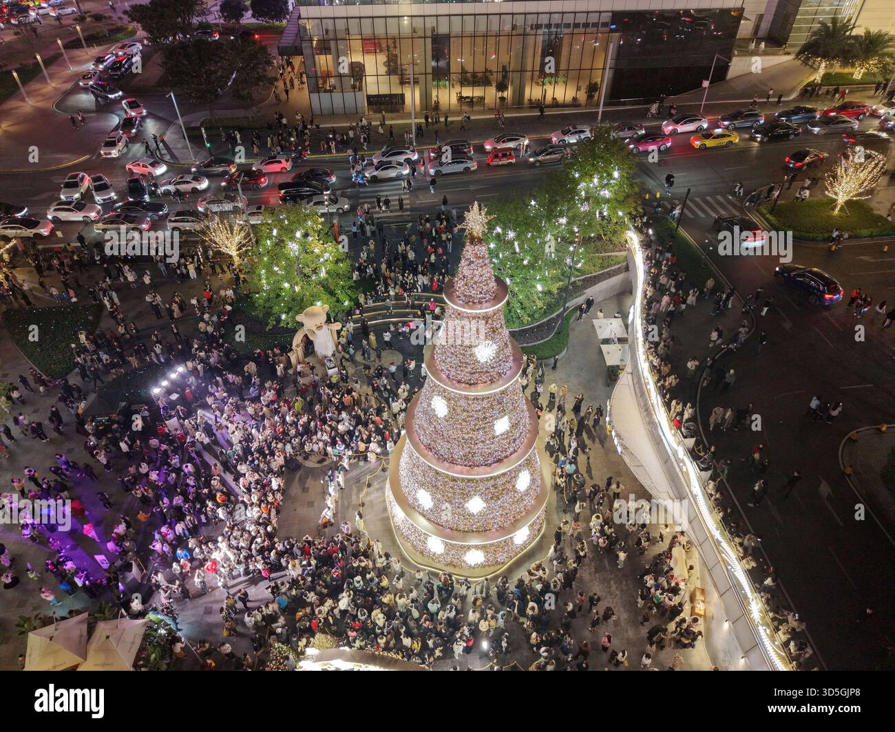 CHONGQING, CHINA - NOVEMBER 15, 2025 - Tourists play around a lit 21 ...
