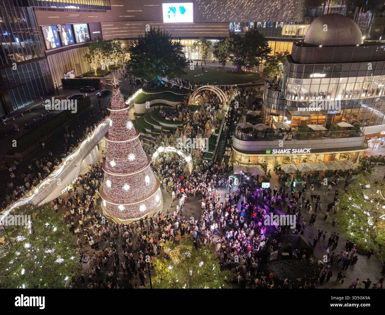 CHONGQING, CHINA - NOVEMBER 15, 2025 - Tourists play around a lit 21 ...