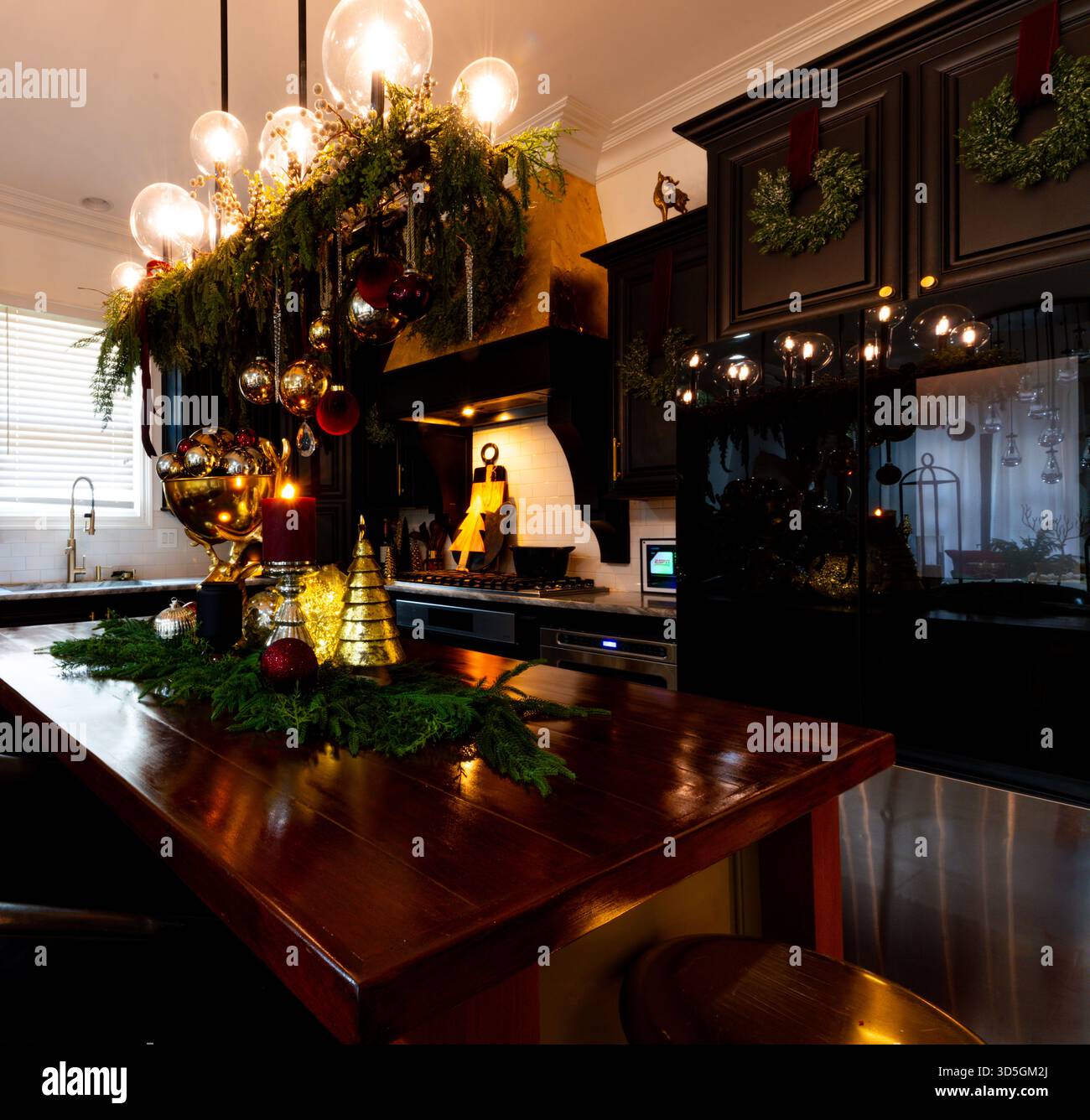 A modern Christmas kitchen decorated with warm holiday accents ...