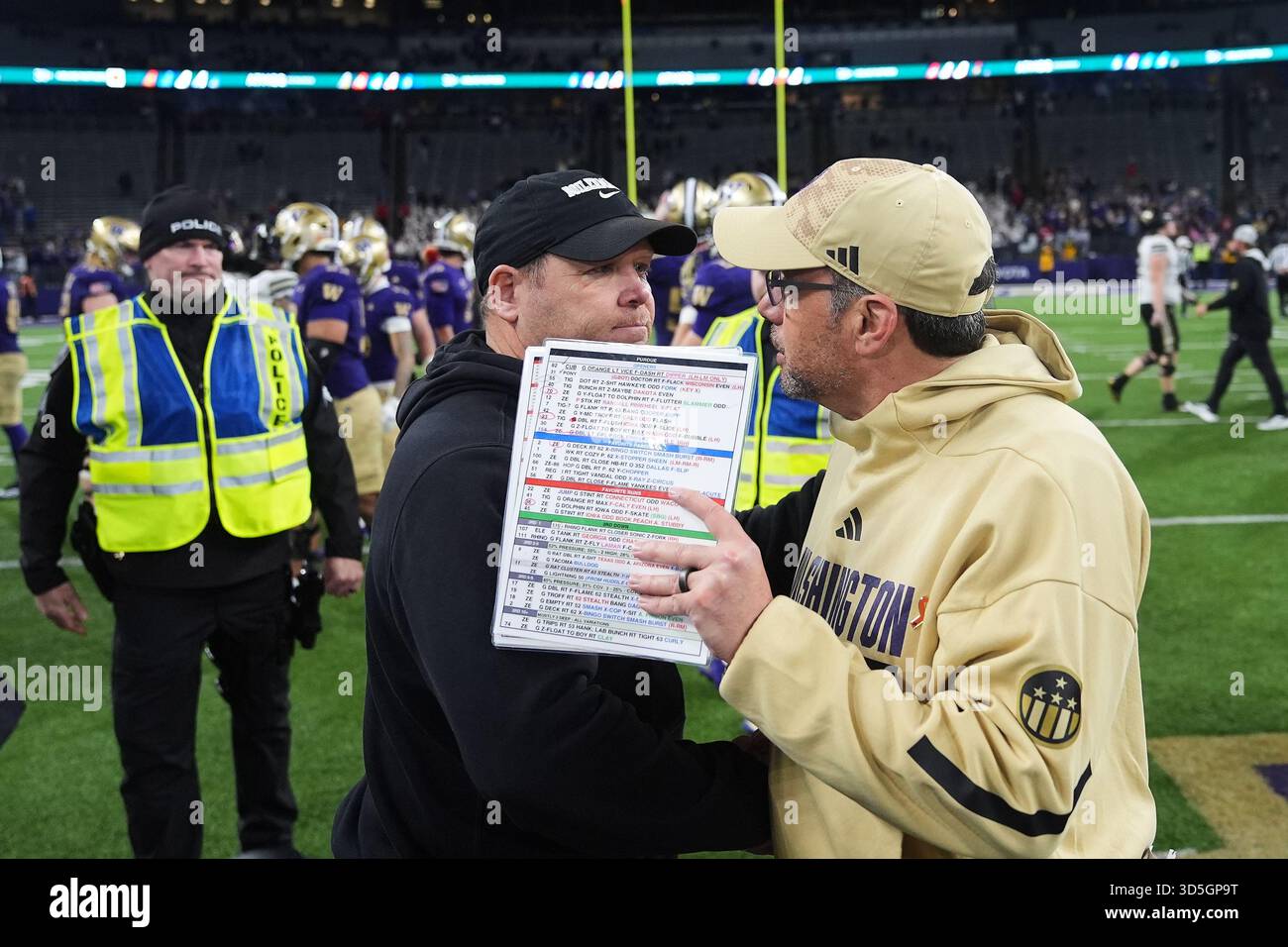 Purdue head coach Barry Odom, left, greets Washington head coach Jedd ...
