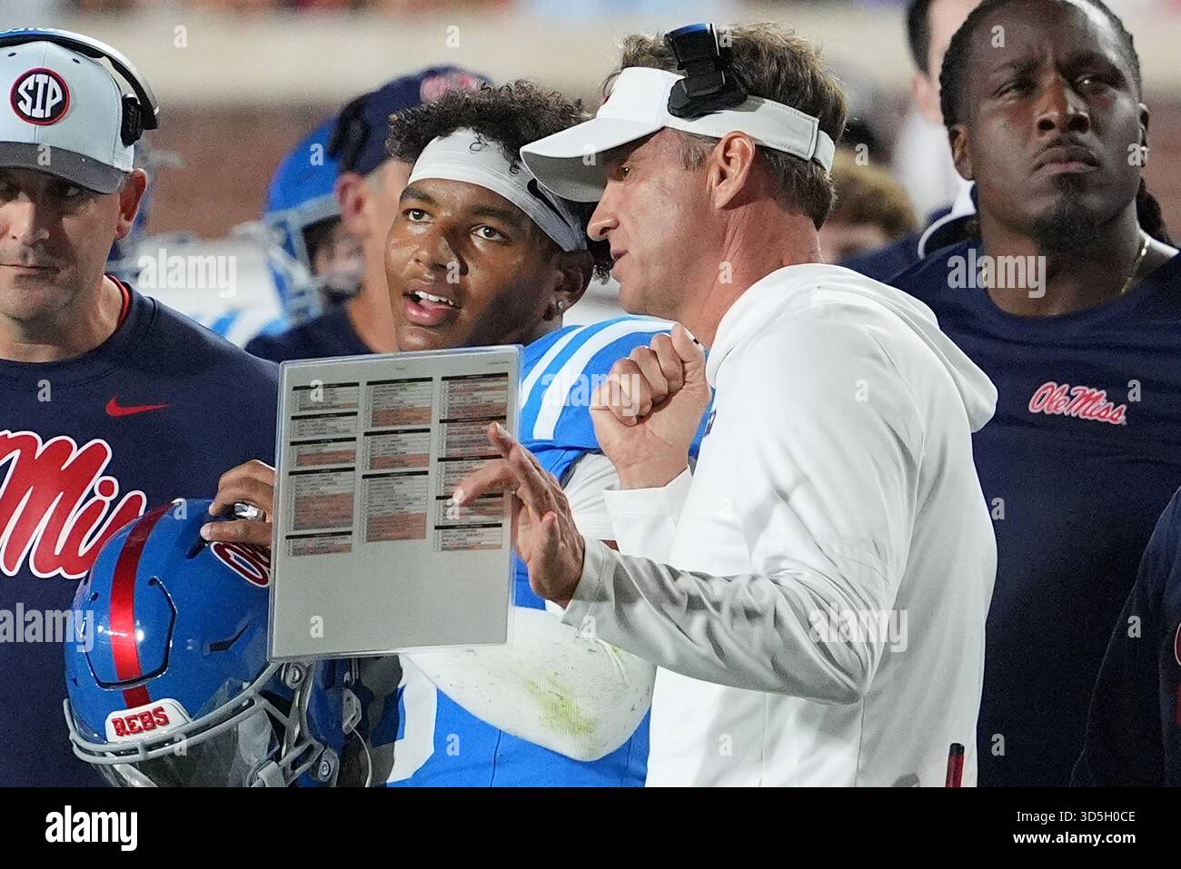 Mississippi head coach Lane Kiffin, right, confers with quarterback ...