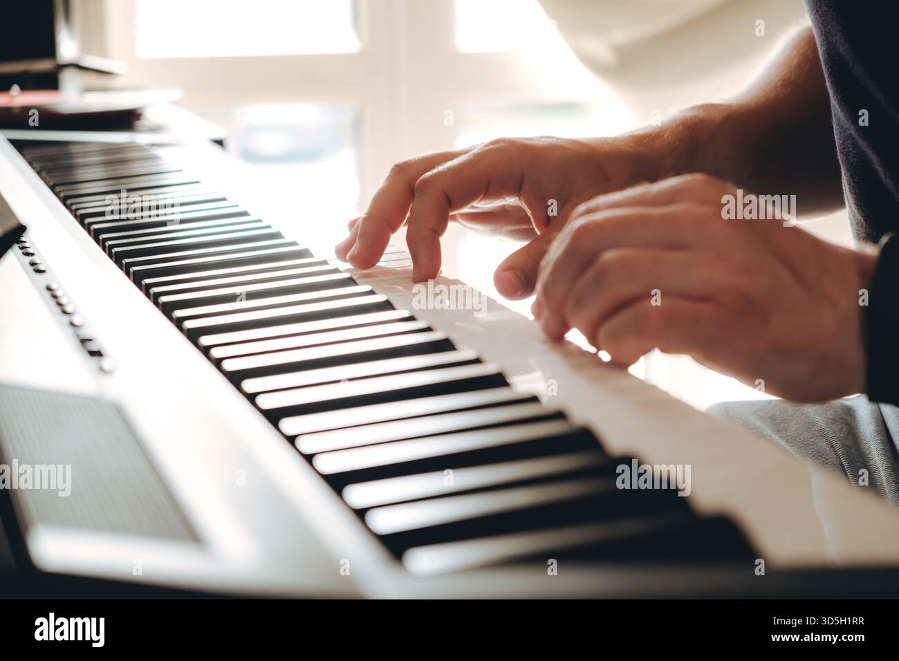 An unrecognizable man learns to play the piano. Music lesson. Musical ...