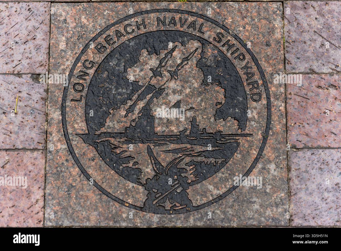 The emblem of the Long Beach Naval Shipyard is etched in granite ...