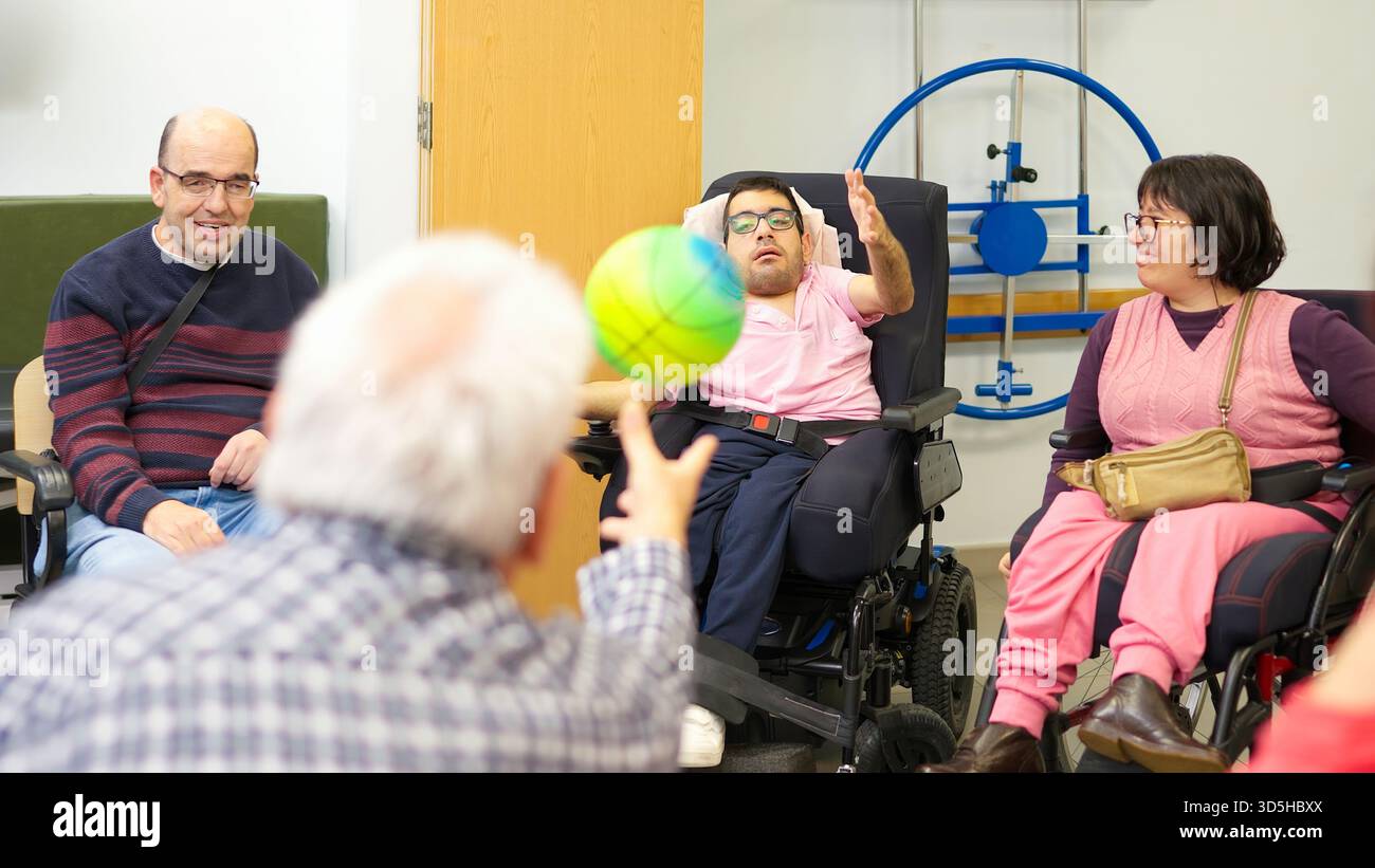 Group of adults with physical disabilities playing ball Stock Photo - Alamy
